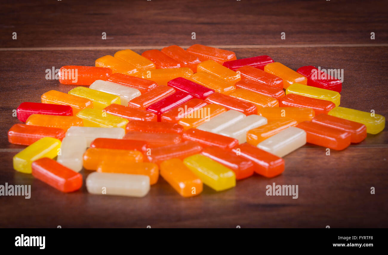 Pile of colorful rectangular hard candy lying on wooden surface Stock ...