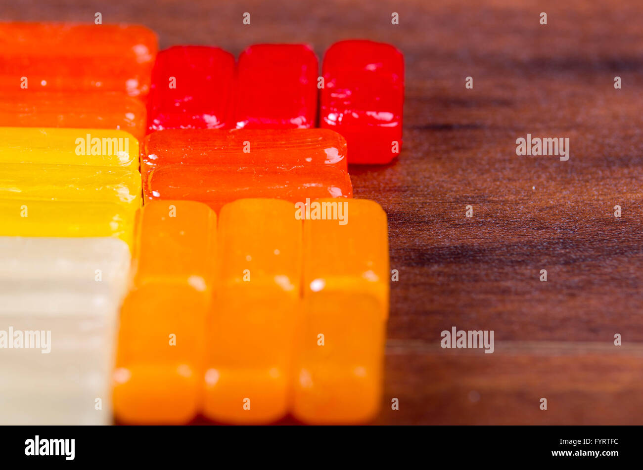 Closeup colorful rectangular hard candy lying on wooden surface Stock ...