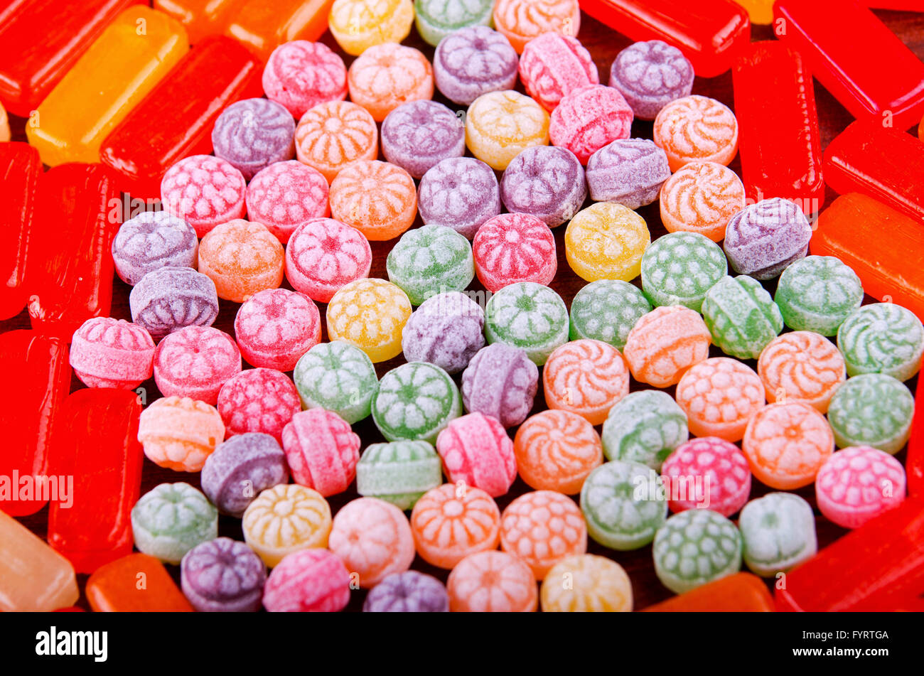 Closeup variation of colorful hard candy lying mixed as seen from above ...
