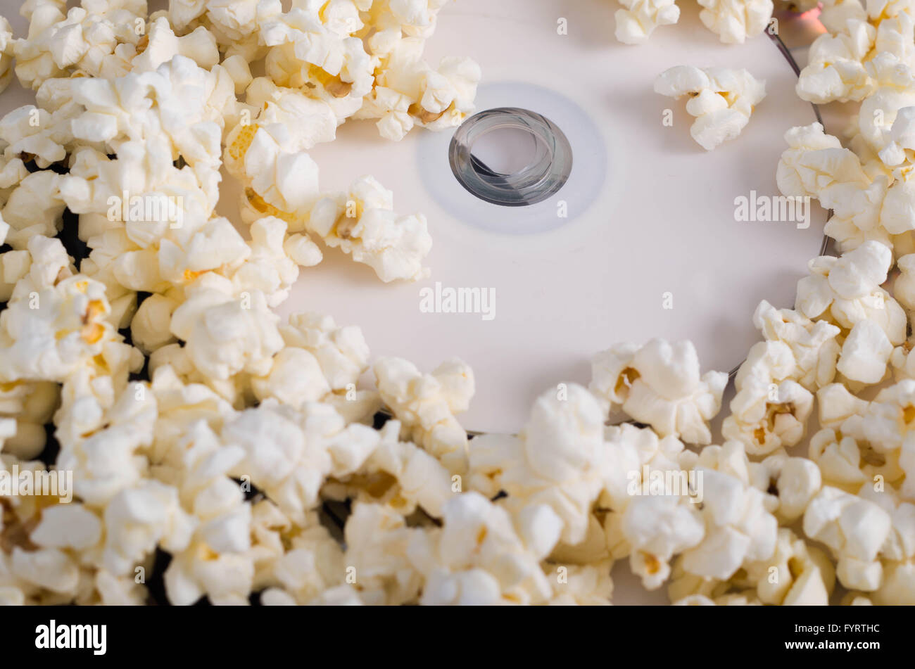 Closeup pile of white fluffy popcorn with dvd disc in the middle Stock ...