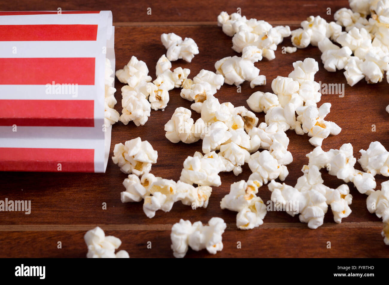 Red white striped container box lying tipped over on wooden surface ...
