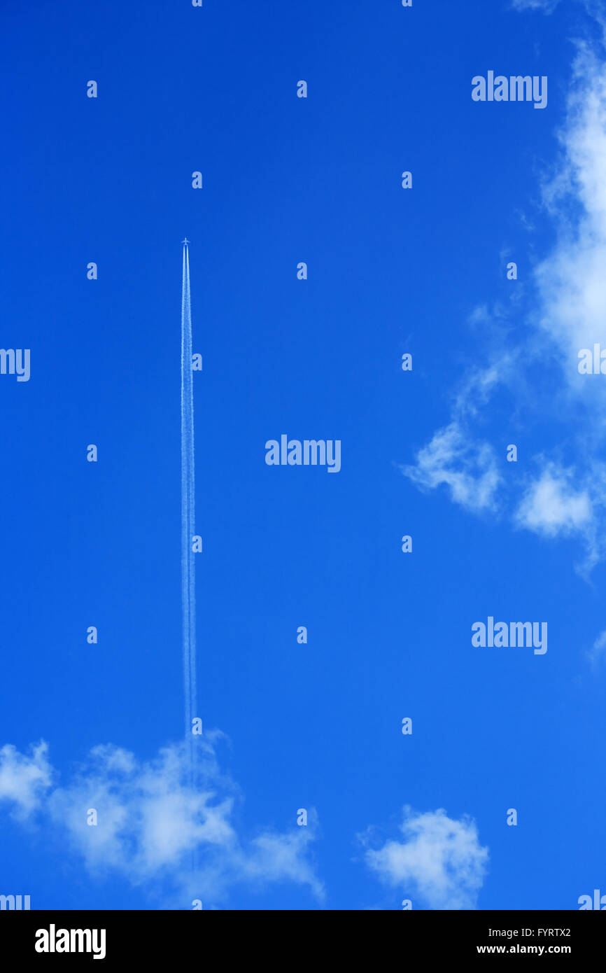 Airplane make vertical take-off against blue sky Stock Photo - Alamy