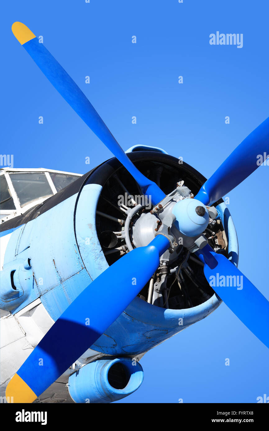Closeup of old airplane engine with propeller against blue sky ...