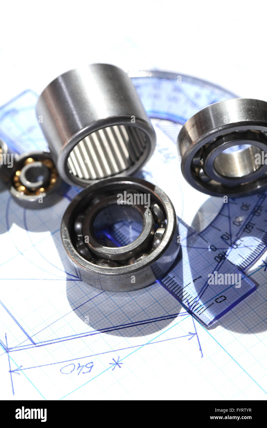 Industrial concept. Few ballbearings near ruler on graph paper ...