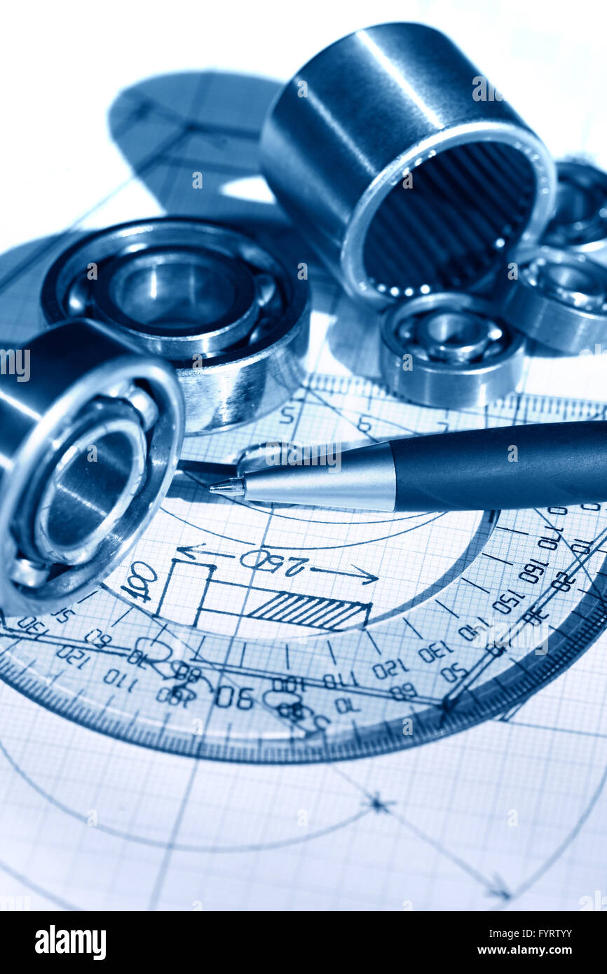 Industrial concept. Few ballbearings near ruler on graph paper ...
