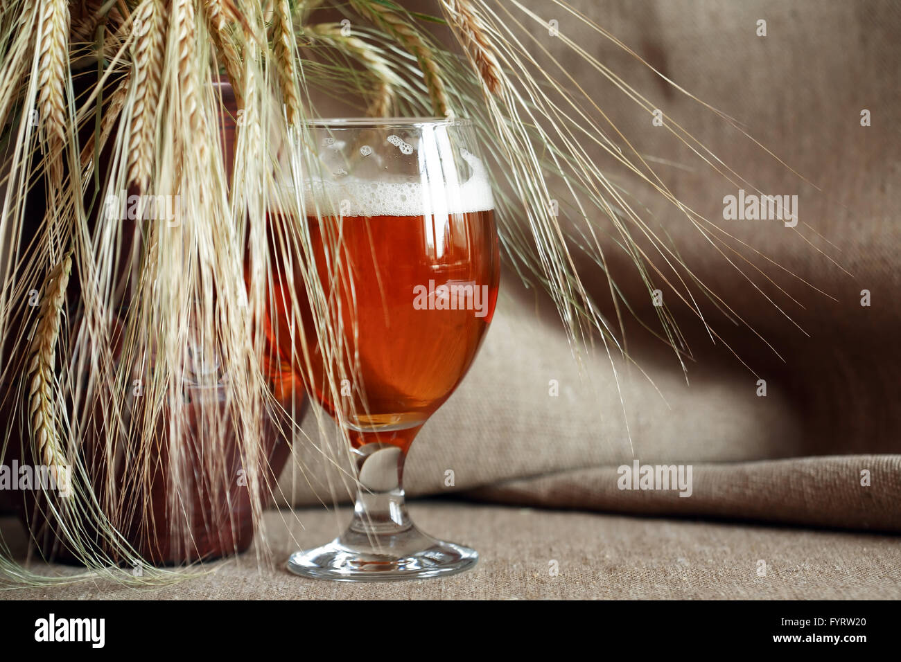 Glass of beer on canvas background near wheat ears Stock Photo - Alamy