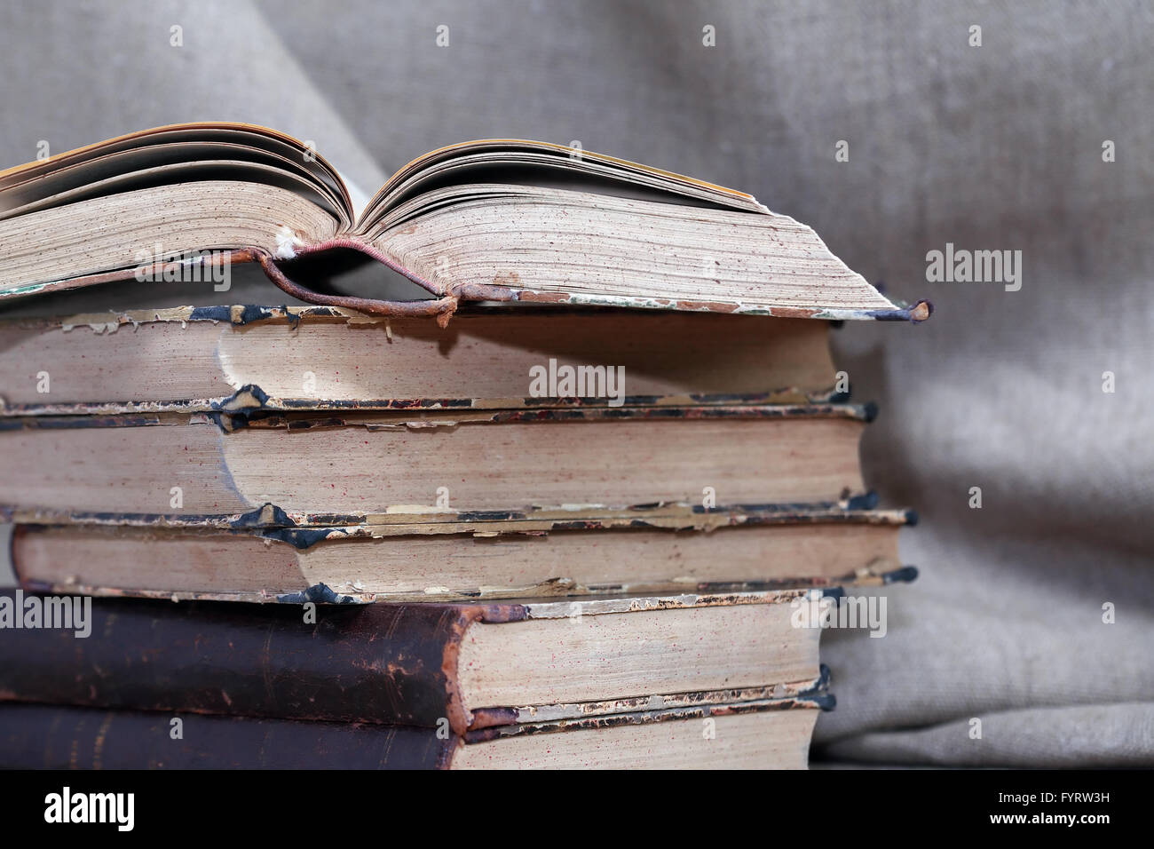 Closeup of stack of old books on canvas background Stock Photo - Alamy