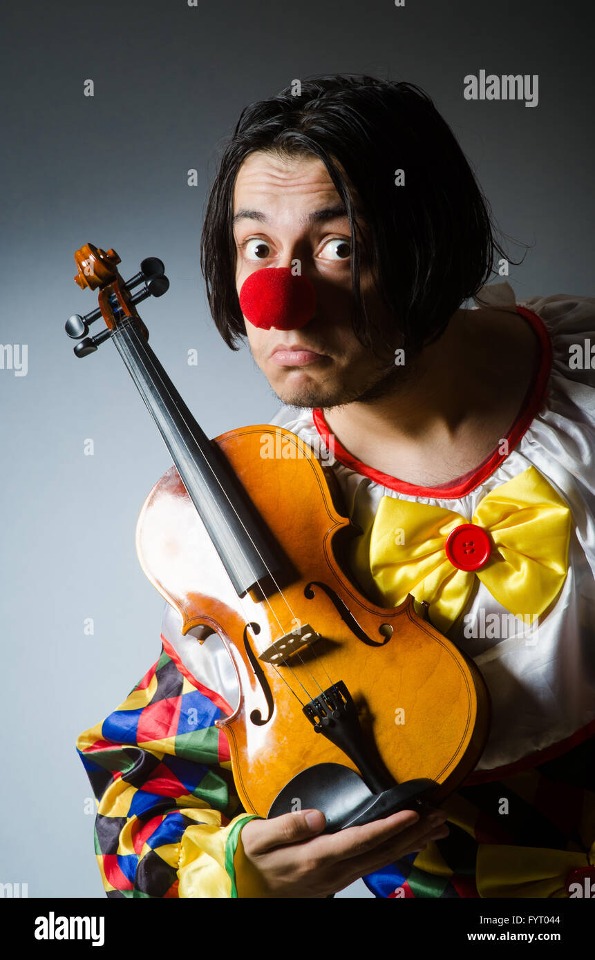 Funny violin clown player in musical concept Stock Photo - Alamy