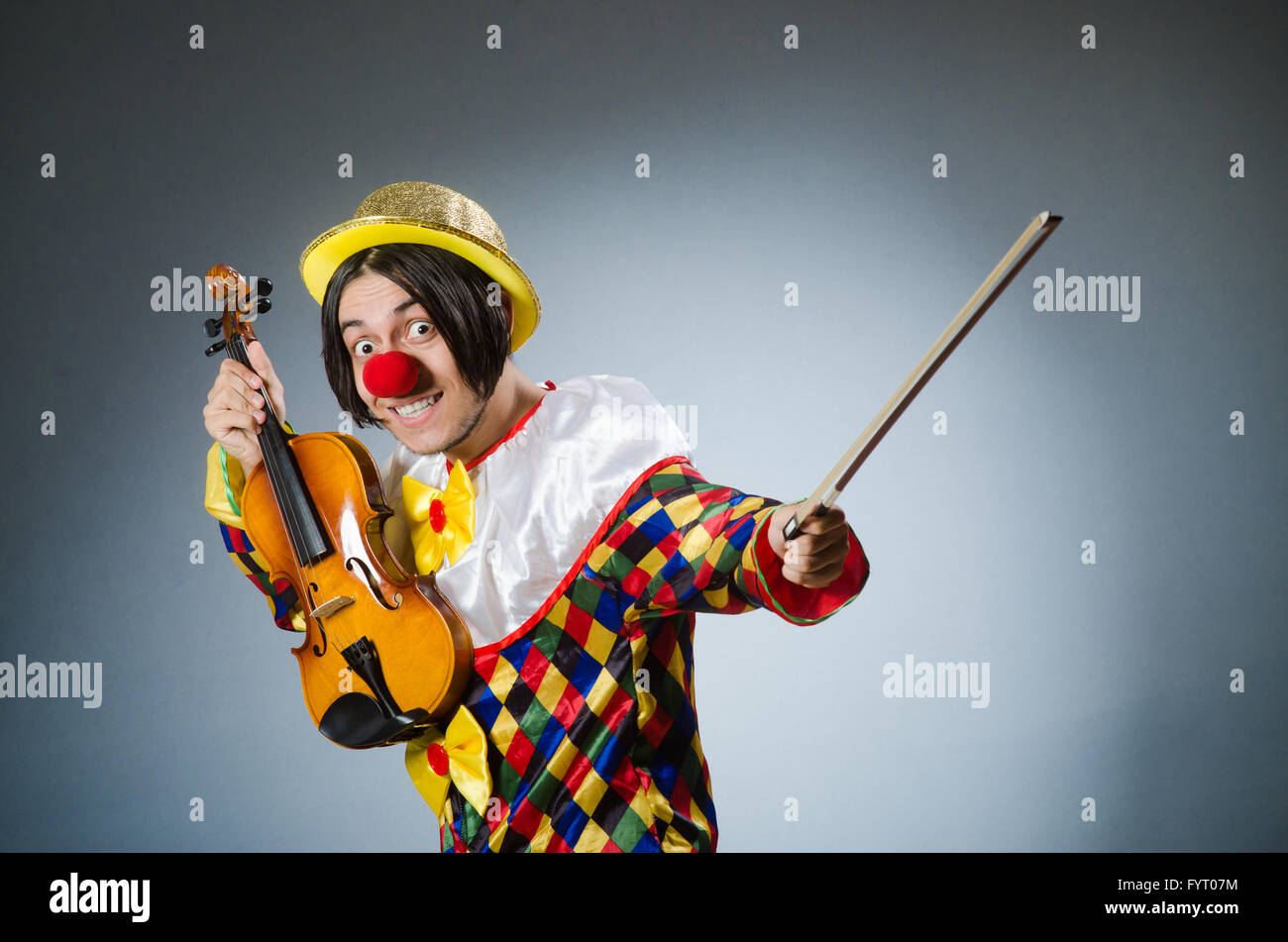Funny violin clown player in musical concept Stock Photo - Alamy