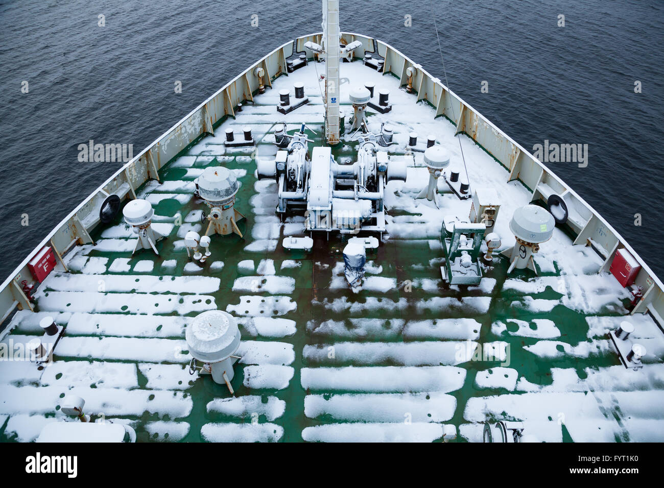 Forepeak ship winch and ventilation pipes covered with snow Stock Photo ...