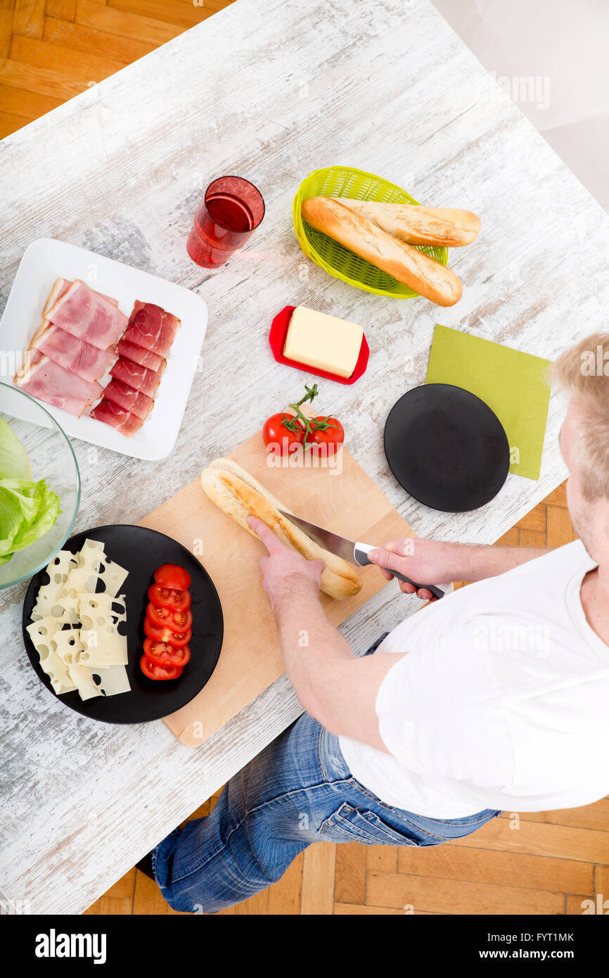 Young man preparing a Sandwich Stock Photo - Alamy