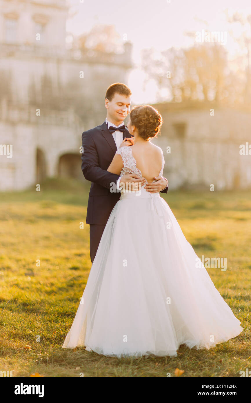 Happy wedding couple hugging and smiling each other on background old ...