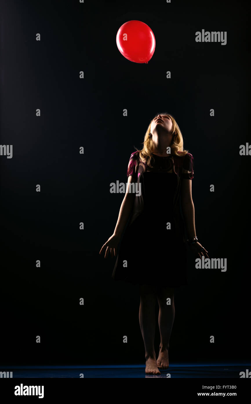 Girl reaching for the balloon Stock Photo - Alamy