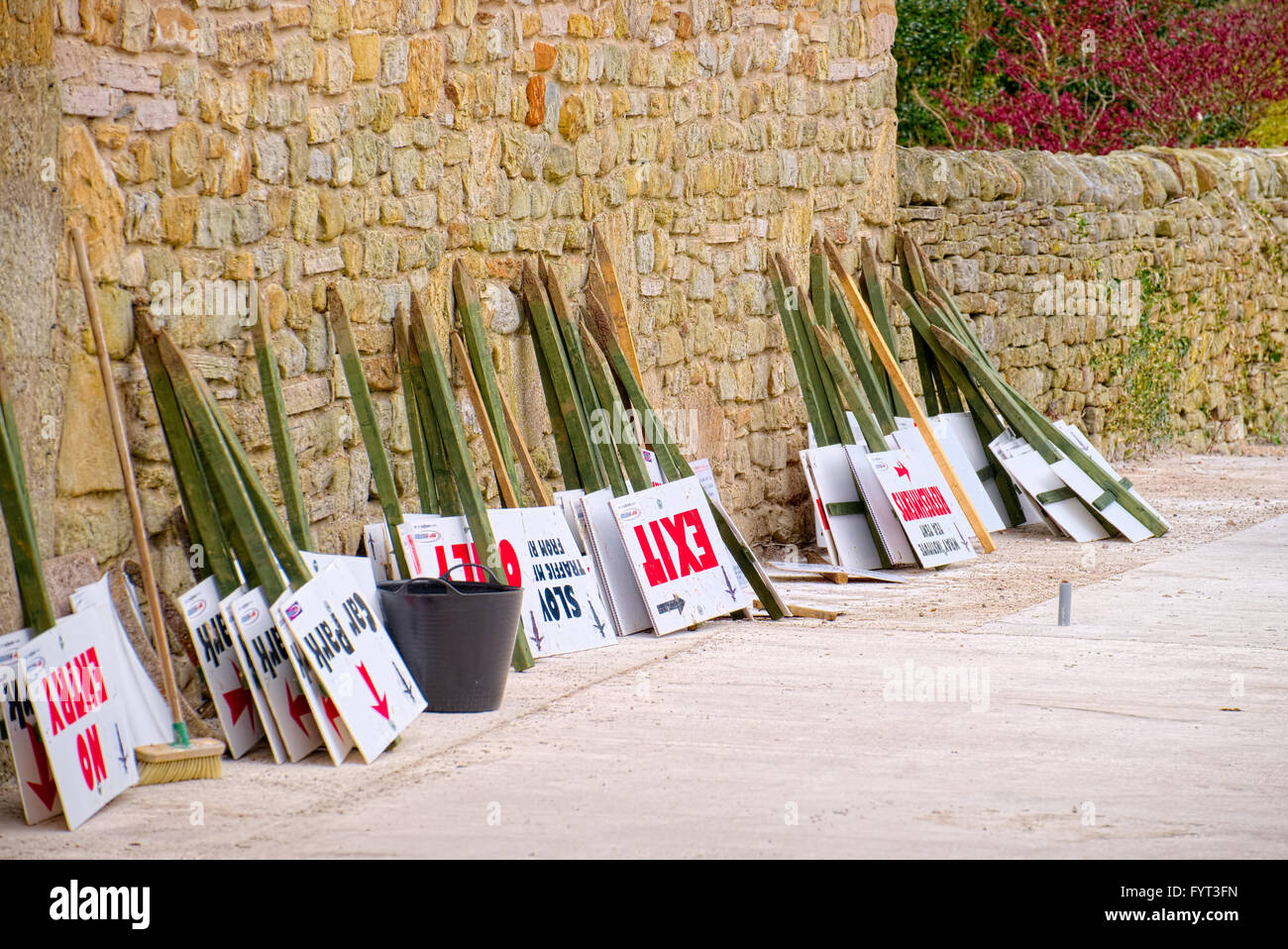 collection of information signs leaning against a wall Stock Photo - Alamy