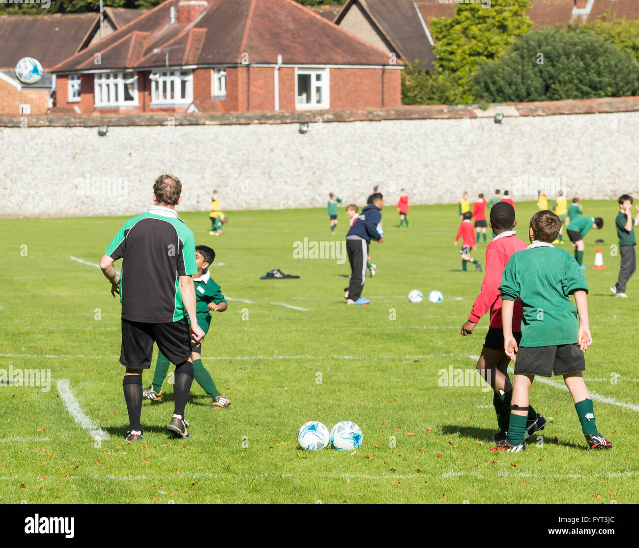 Schoolchildren playing football on private school playing fields in ...