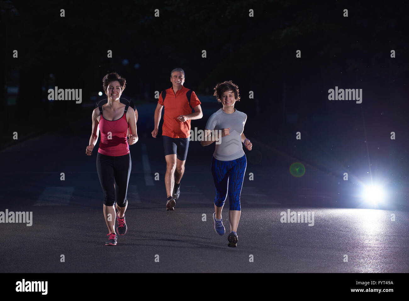 people group jogging at night Stock Photo - Alamy