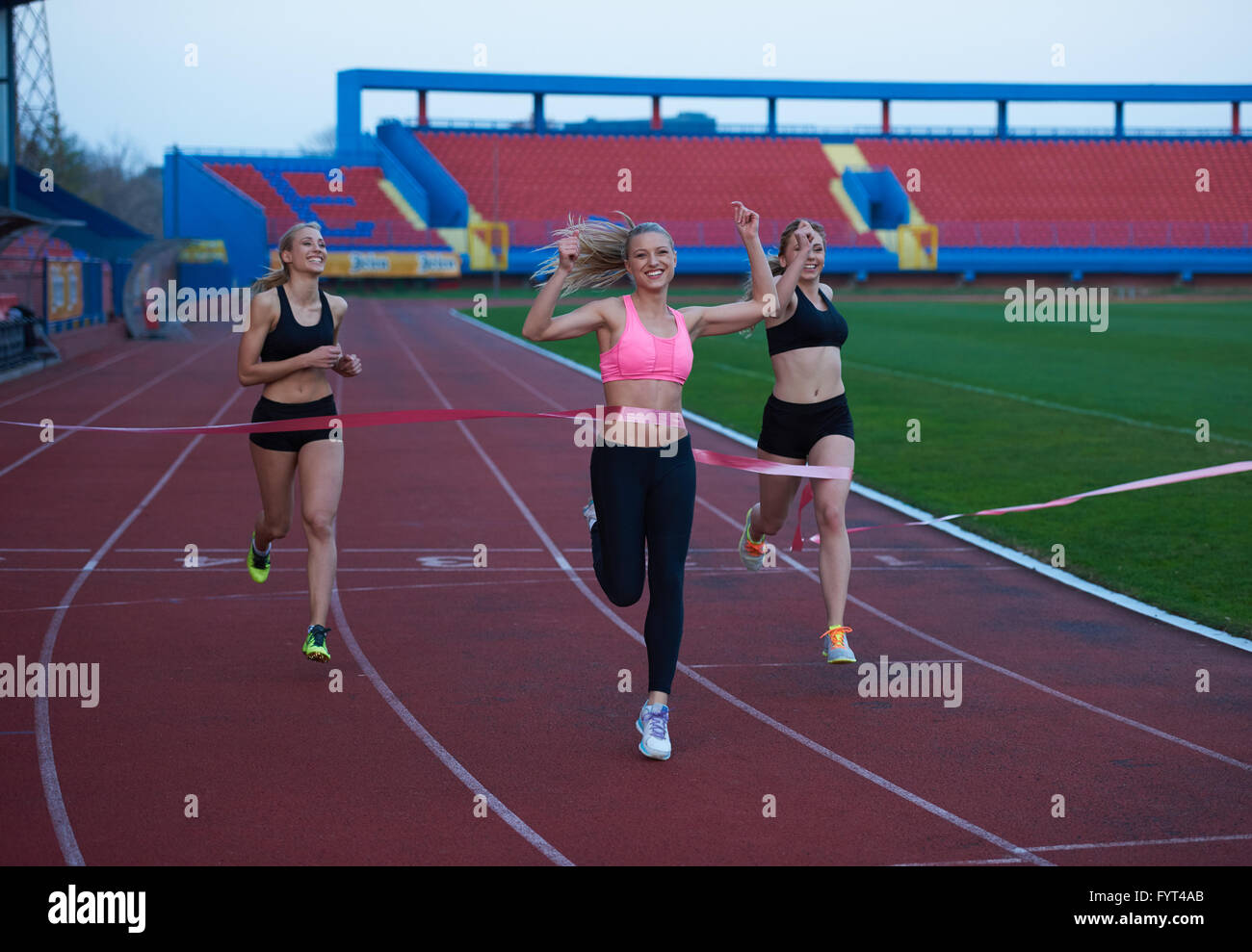 Female Runners Finishing Race Together Stock Photo - Alamy