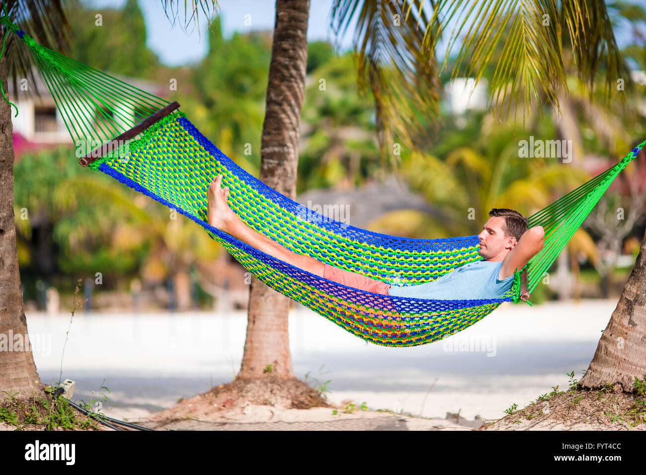 Young man relax in hammock Stock Photo - Alamy