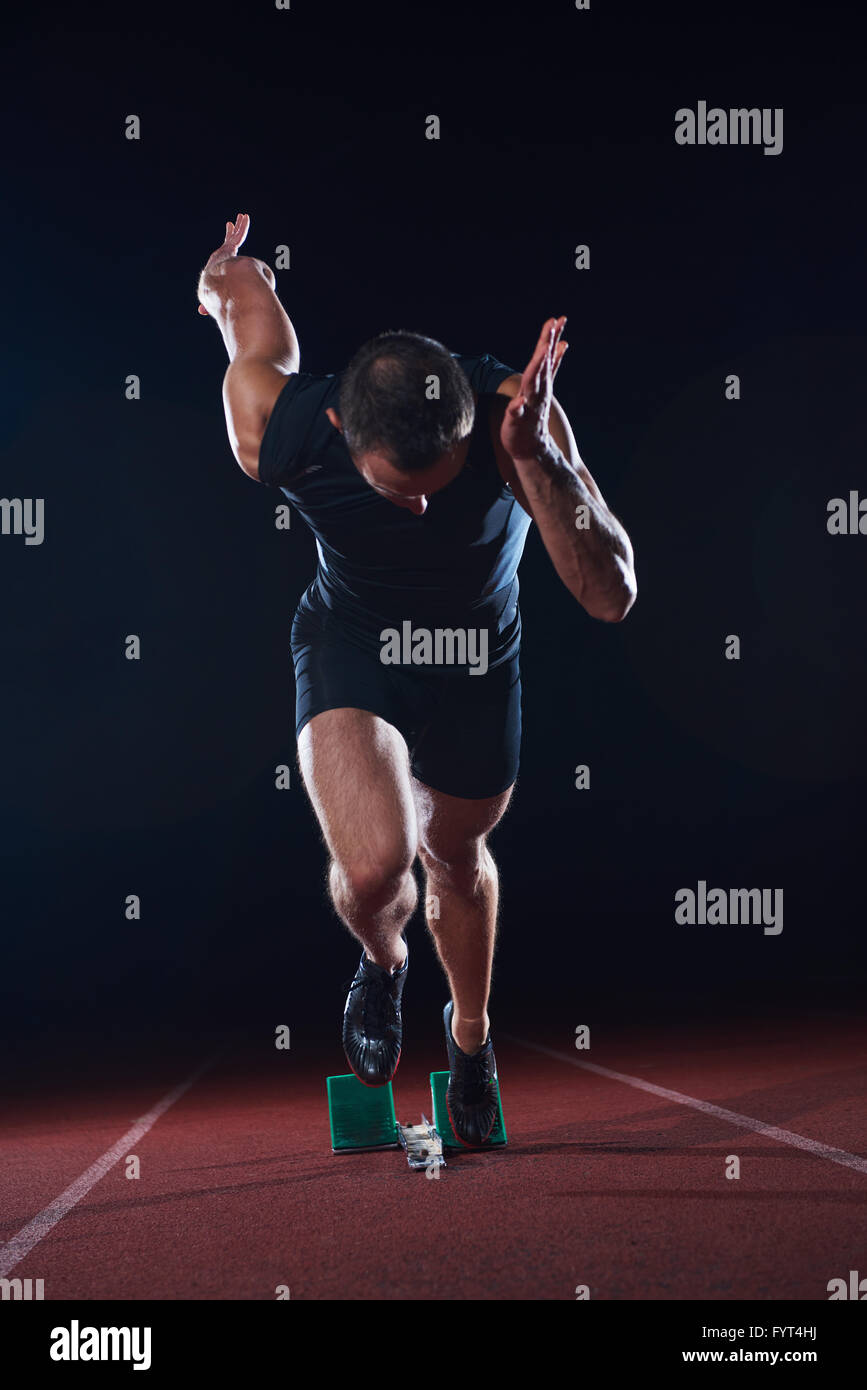 Sprinter leaving starting blocks Stock Photo - Alamy