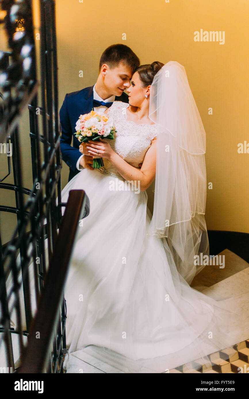 Newly young married couple embracing face-to-face standing at the ...