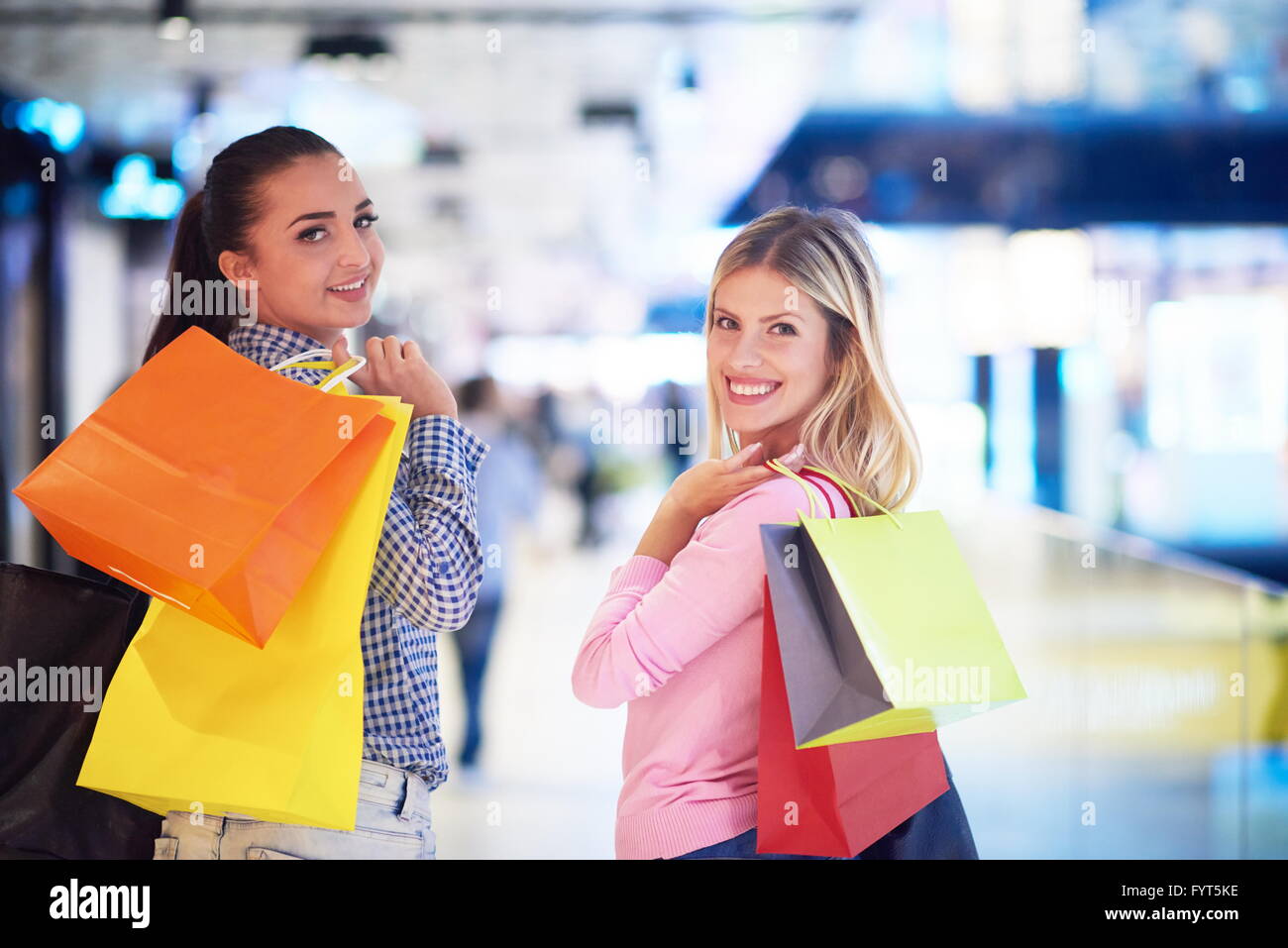 happy young girls in shopping mall Stock Photo - Alamy
