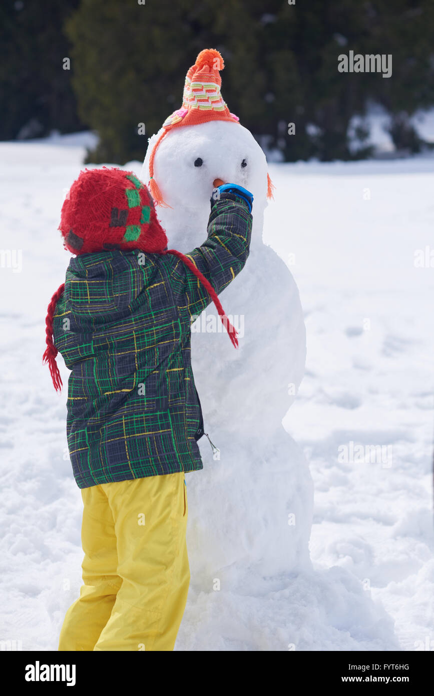 boy making snowman Stock Photo - Alamy