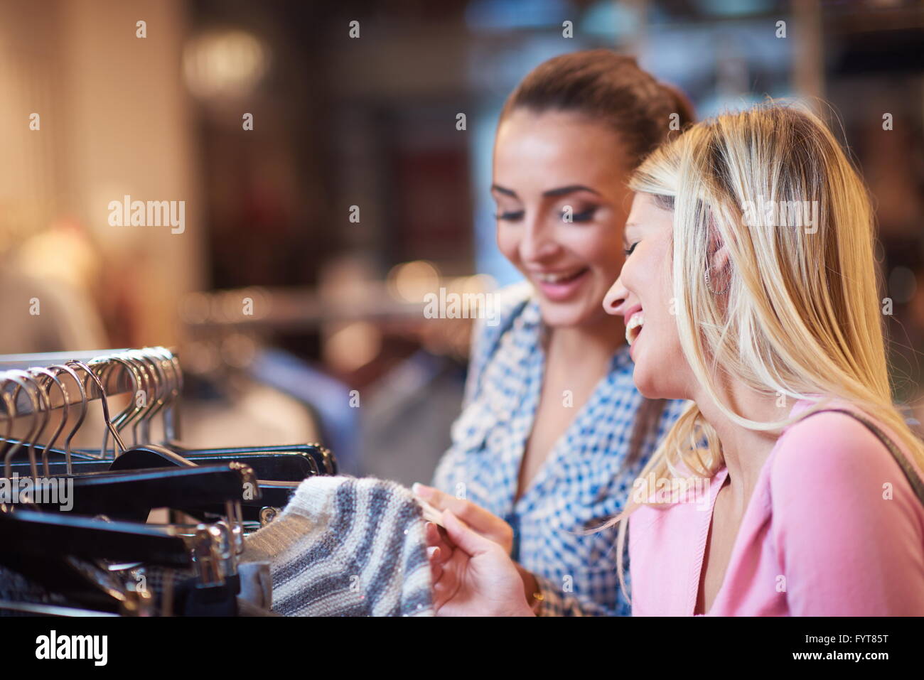 happy young girls in shopping mall Stock Photo - Alamy