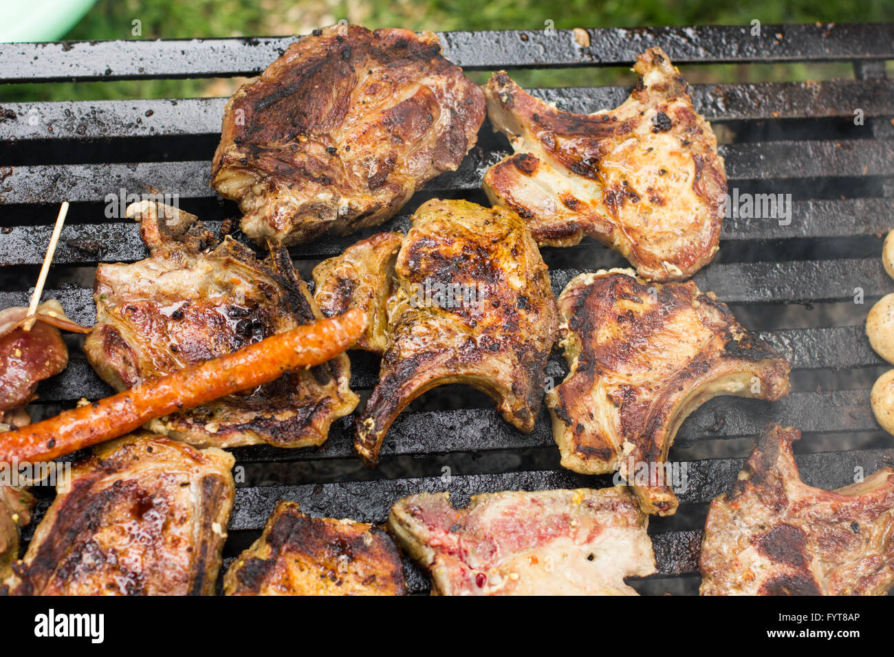 Grilled meat on the barbecue,cooked outdoor Stock Photo - Alamy