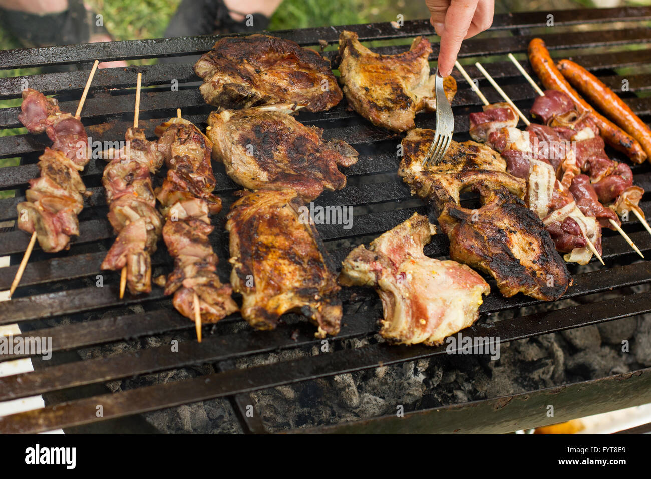 Grilled meat on the barbecue,cooked outdoor Stock Photo - Alamy