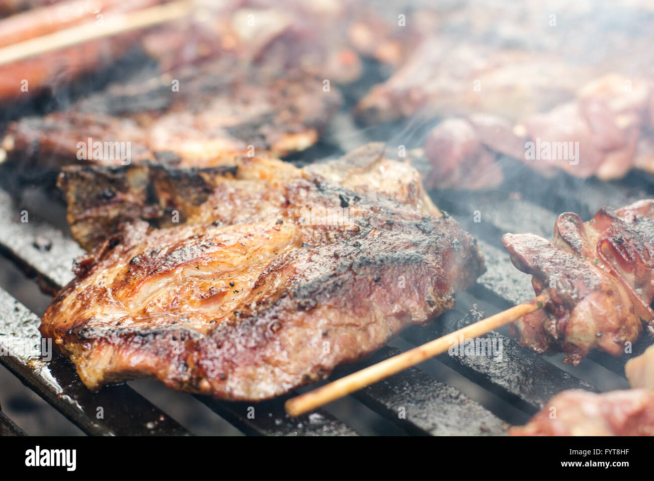 Grilled meat on the barbecue,cooked outdoor Stock Photo - Alamy