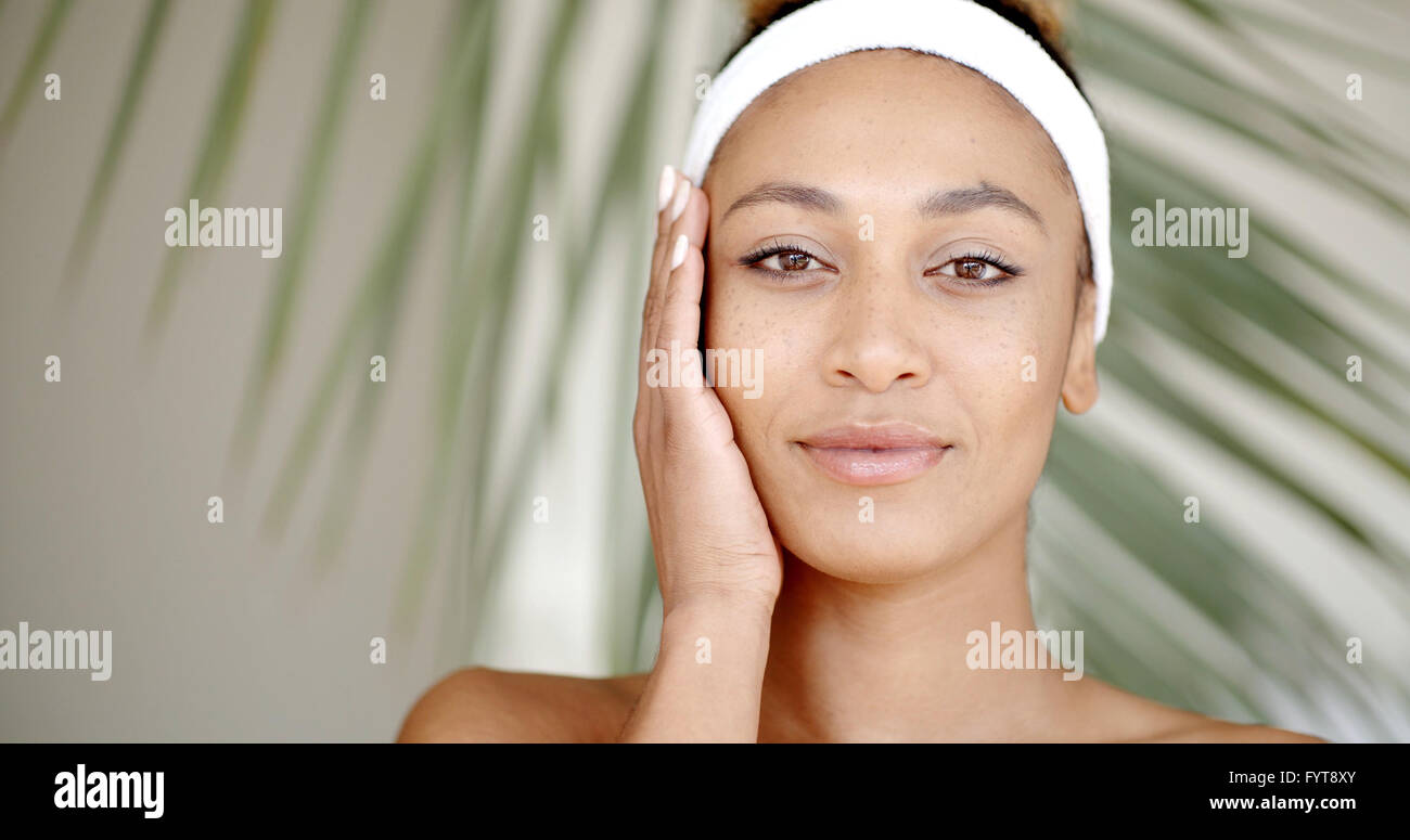 Woman With Makeup Touching Her Face Stock Photo - Alamy