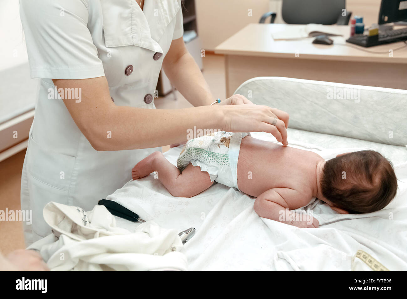 Pediatrician examining littlle newborn baby Stock Photo - Alamy