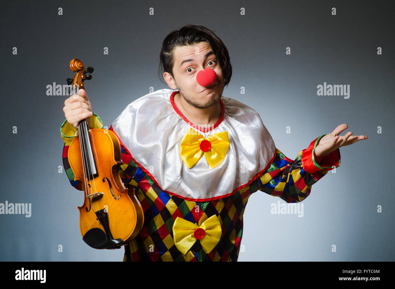 Funny violin clown player in musical concept Stock Photo - Alamy