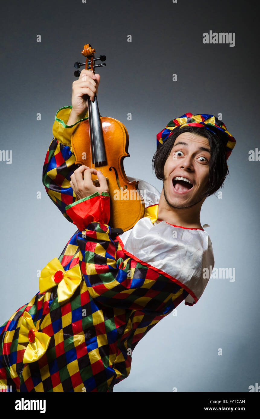 Funny violin clown player in musical concept Stock Photo - Alamy