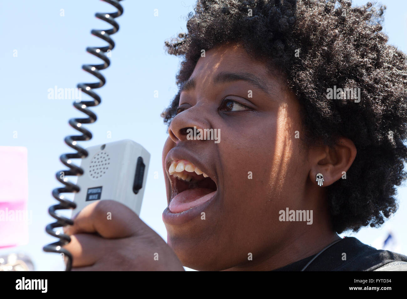 African-American liberal activist yelling slogans in bullhorn mic ...