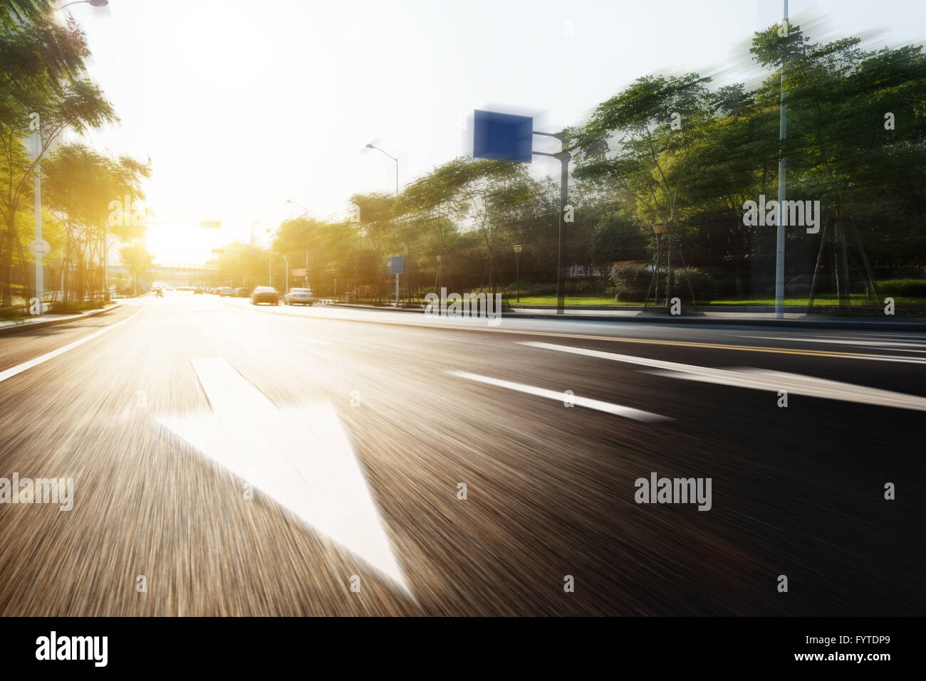 sunlight and empty asphalt road with traffic sign Stock Photo - Alamy