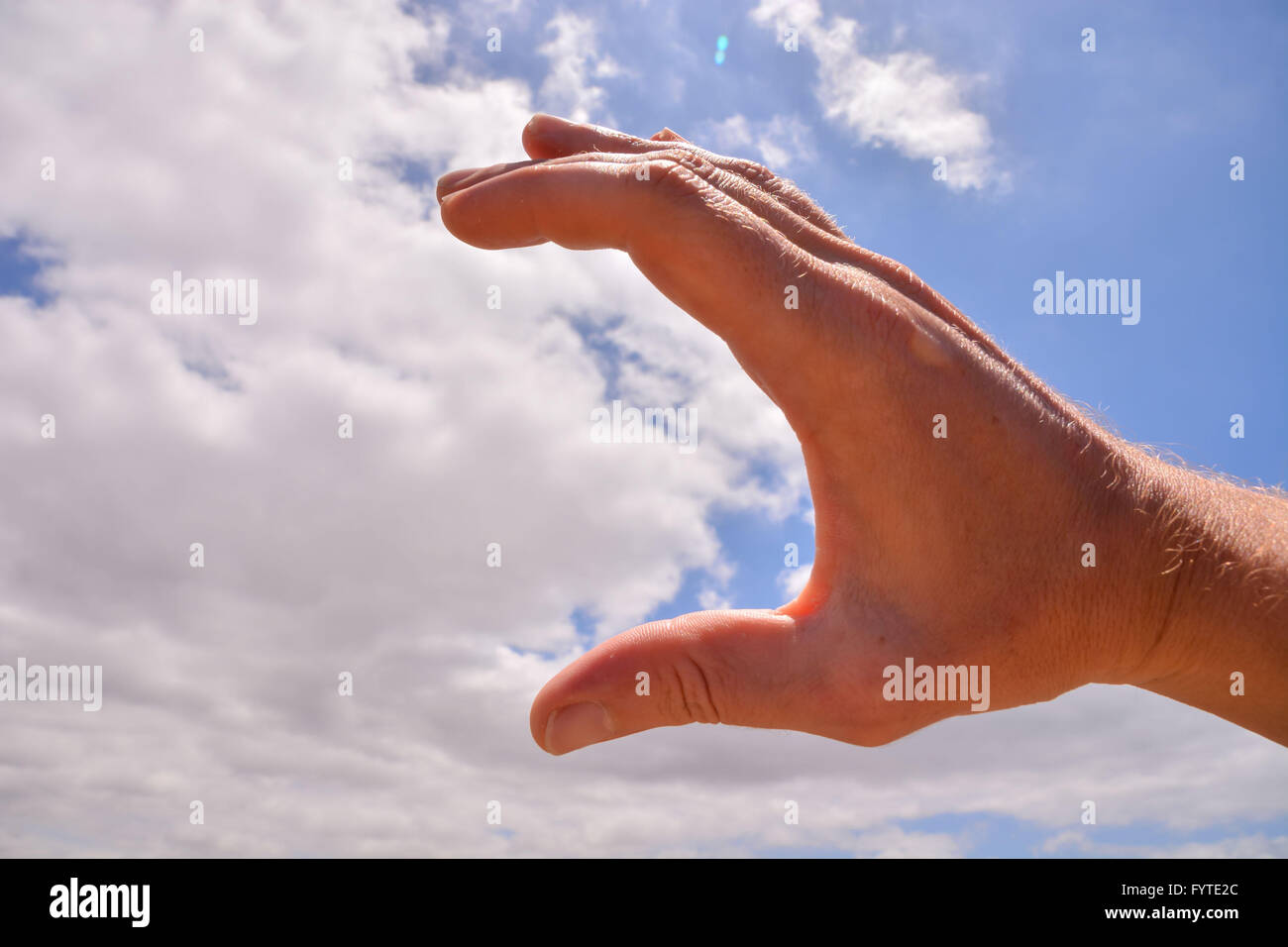 Hand over a Cloudy Sky Stock Photo - Alamy
