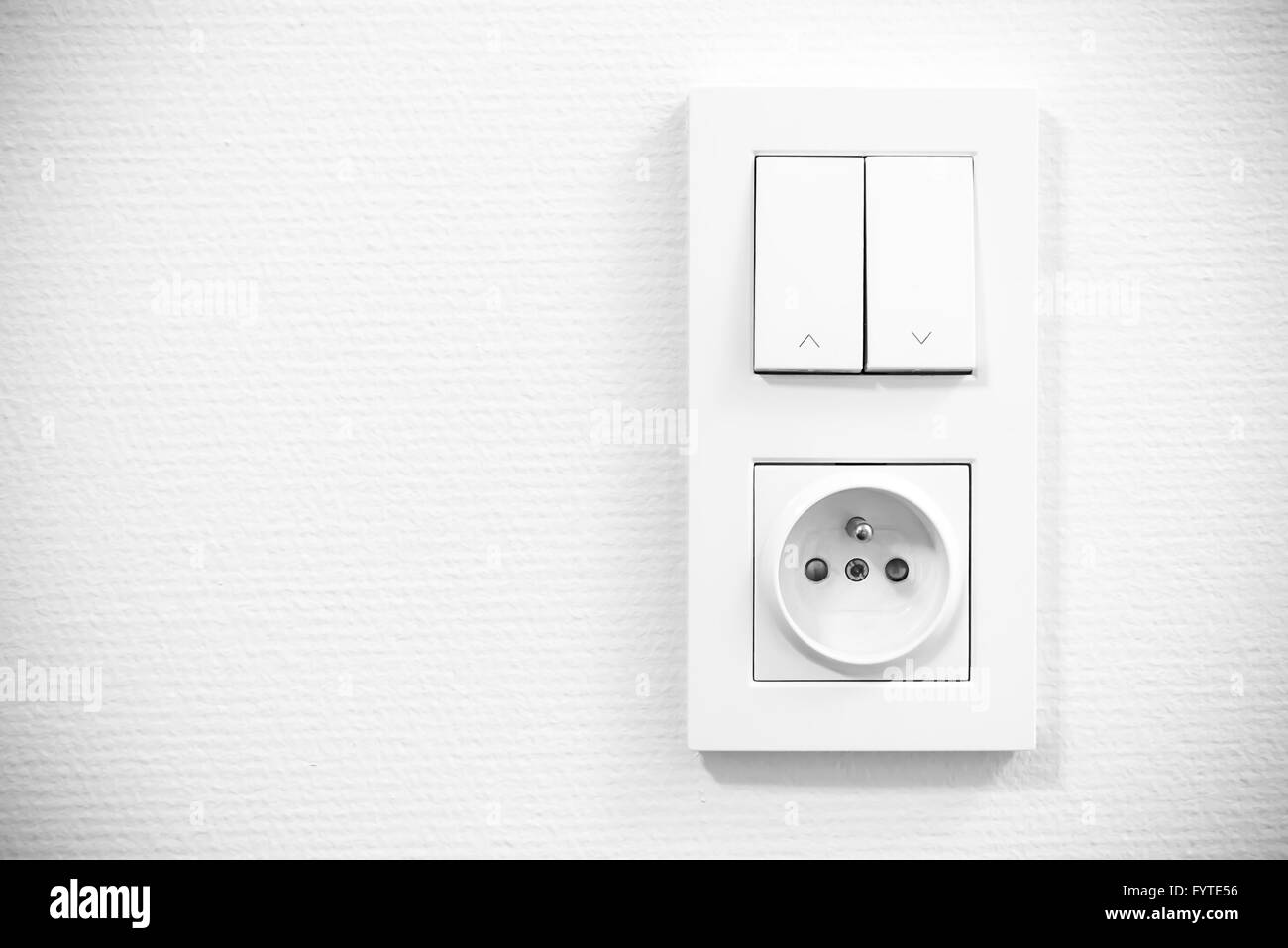 light switch and socket in frame on the wall Stock Photo - Alamy