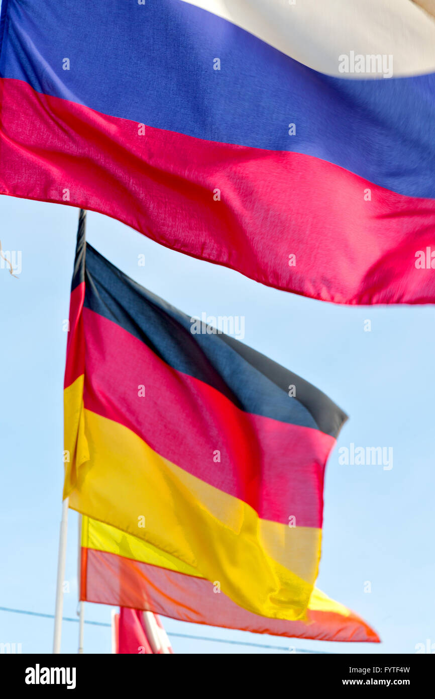 world waving flag in the blue sky and spain Stock Photo - Alamy