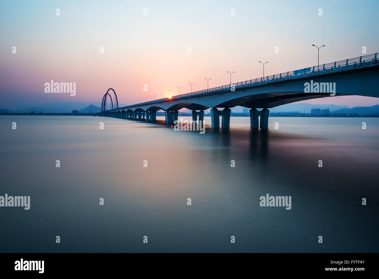 sunrise,sunset skyline and bridge over river Stock Photo - Alamy