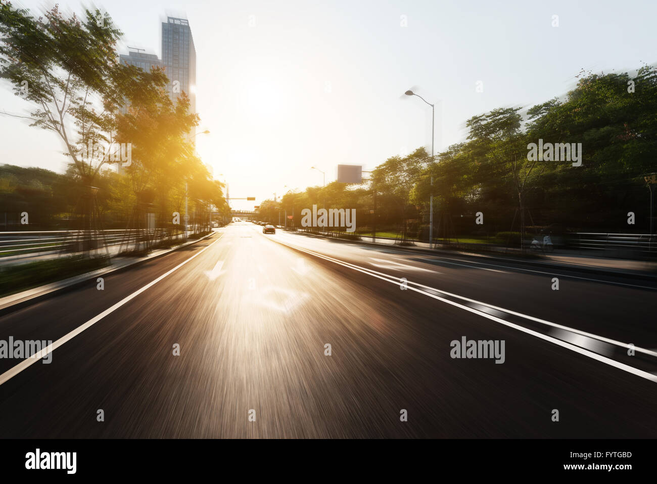 sunlight skyline and road by modern buildings Stock Photo - Alamy