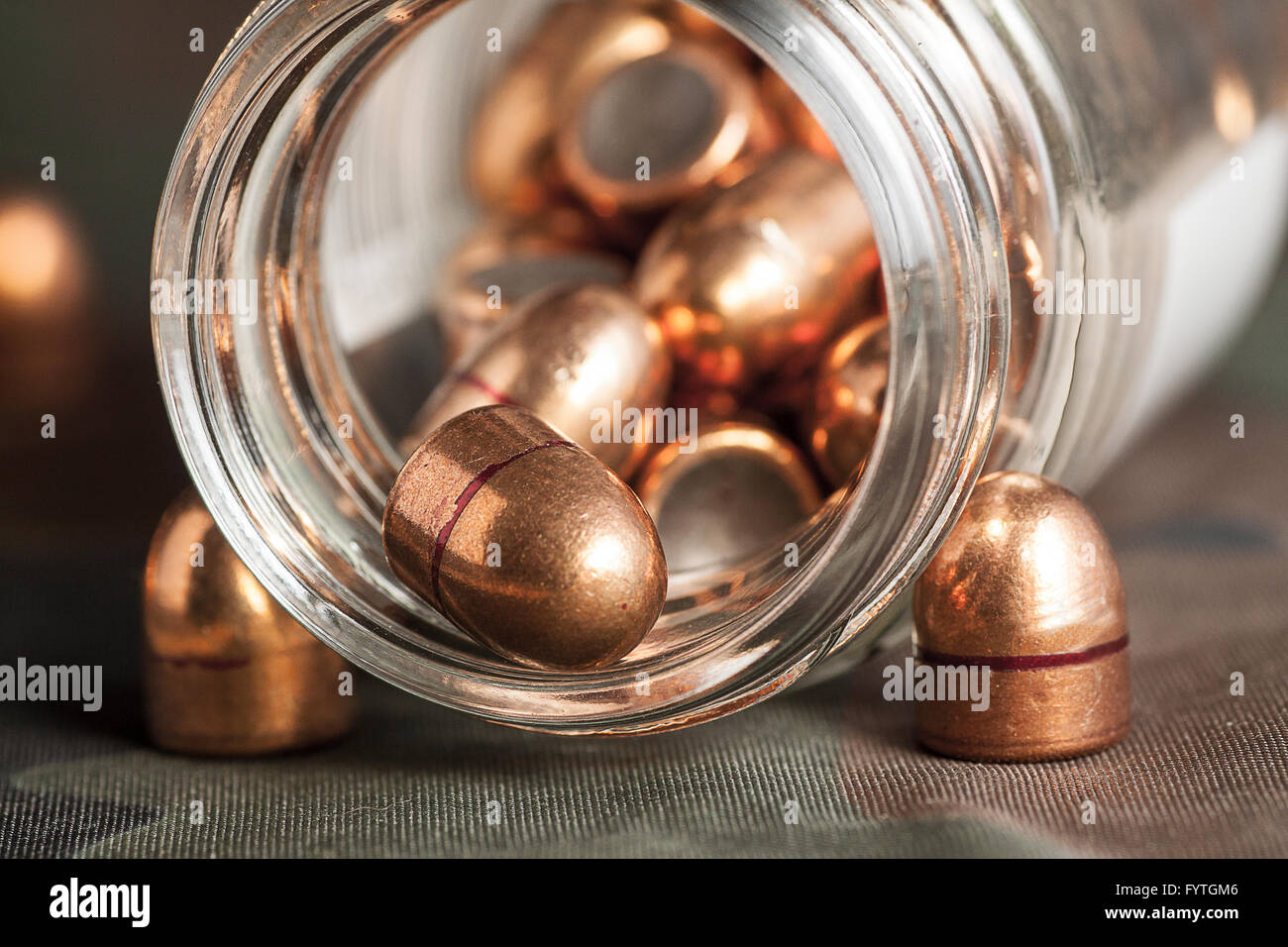 bullets on camouflage background spill out of the banks on camouflage ...