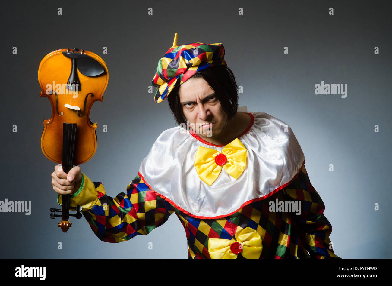 Funny violin clown player in musical concept Stock Photo - Alamy