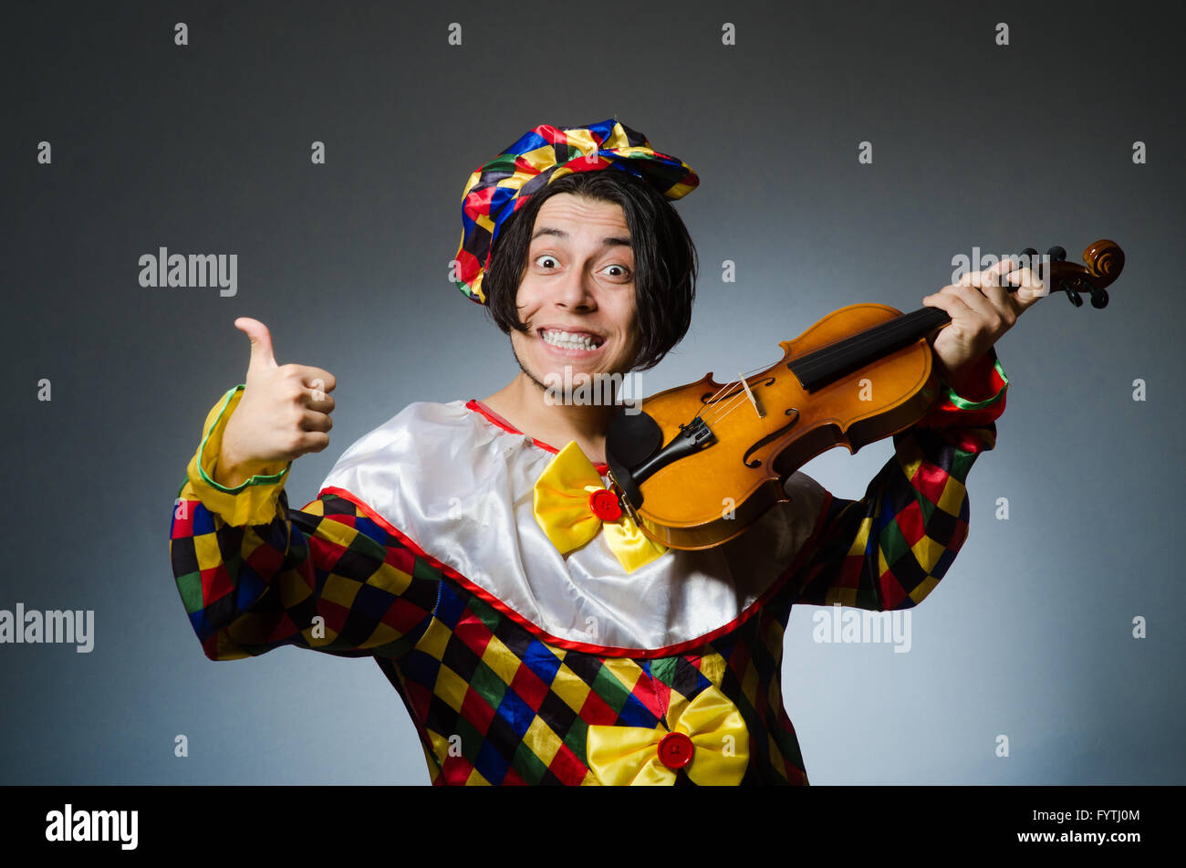 Funny violin clown player in musical concept Stock Photo - Alamy