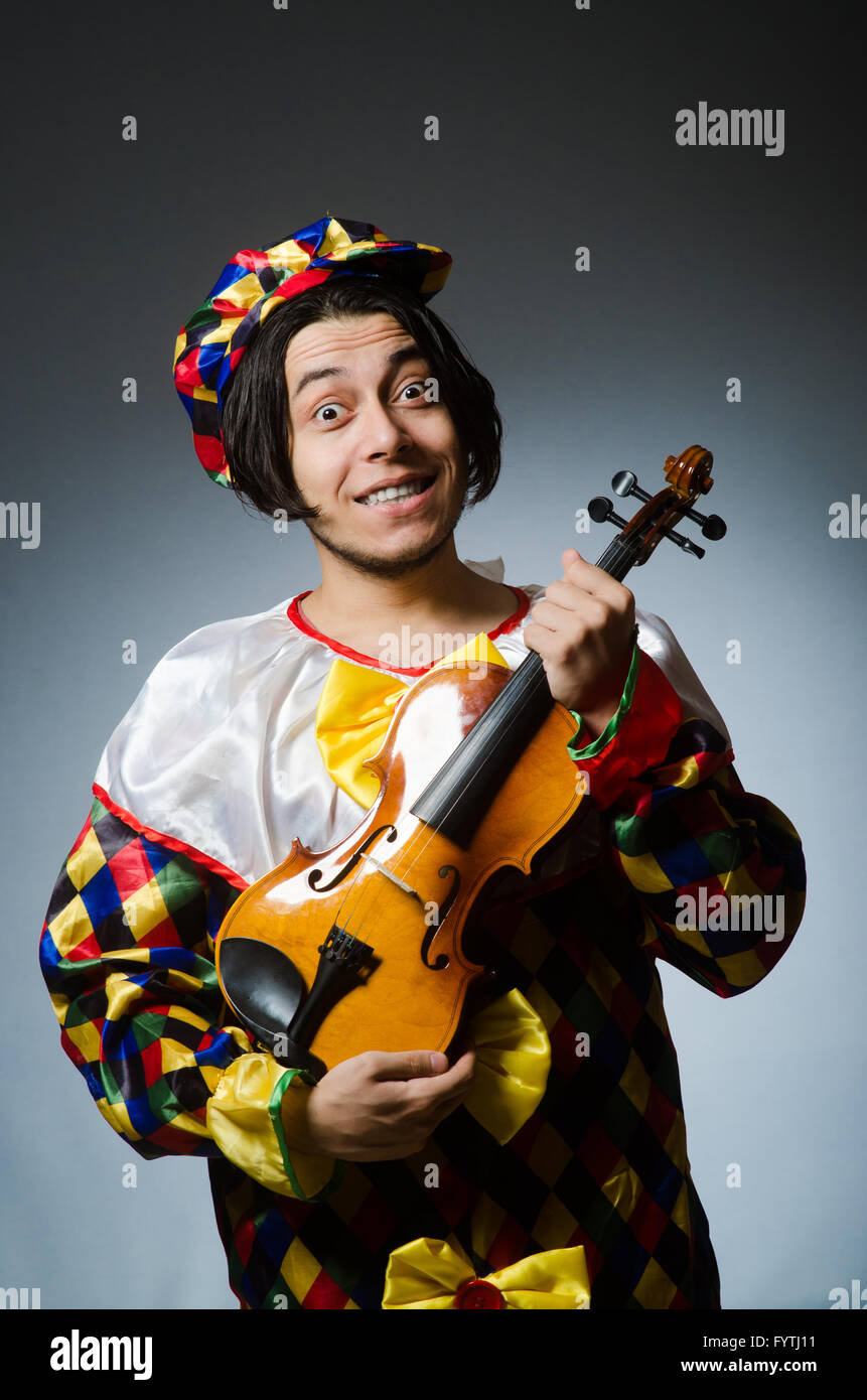 Funny violin clown player in musical concept Stock Photo - Alamy