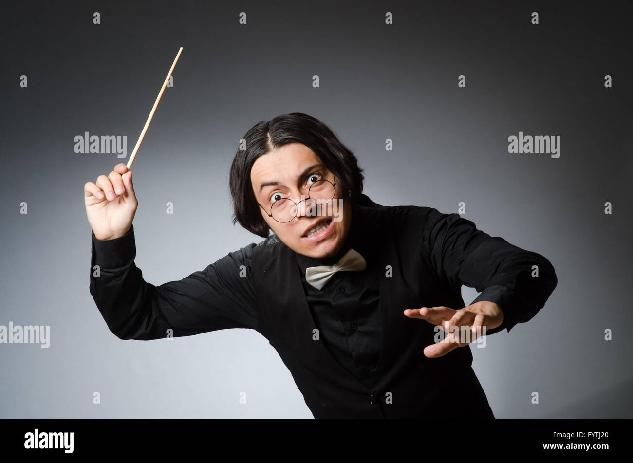Funny conductor in musical concept Stock Photo - Alamy