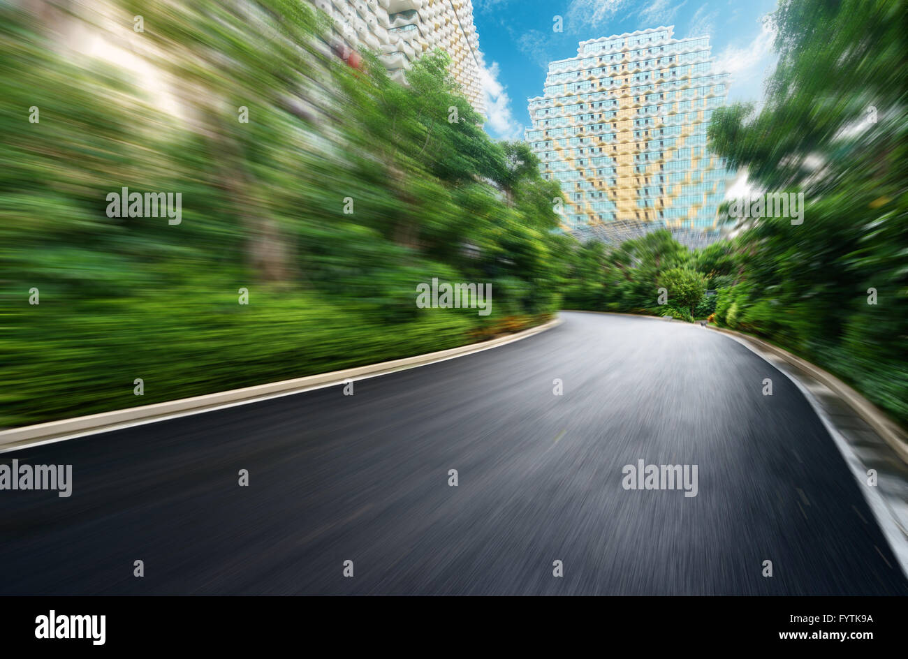 road through trees to moden building Stock Photo - Alamy