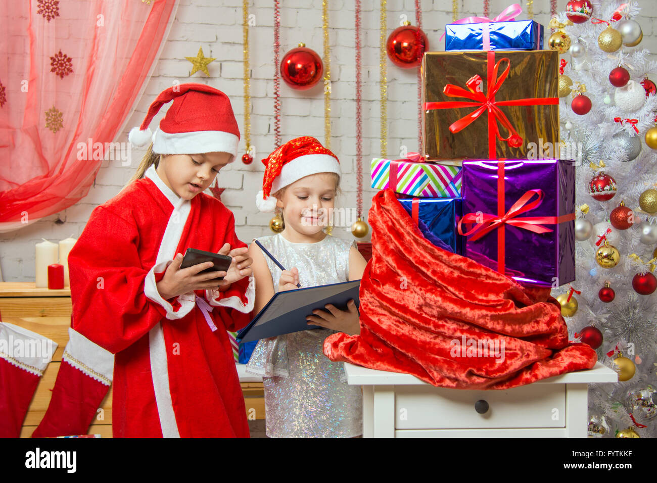 smiling girl in santa helper hat with gift box Stock Photo - Alamy