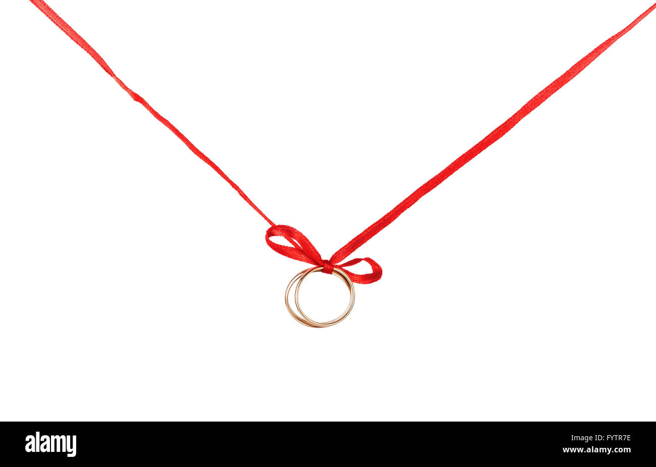 Golden rings on a red ribbon Stock Photo - Alamy