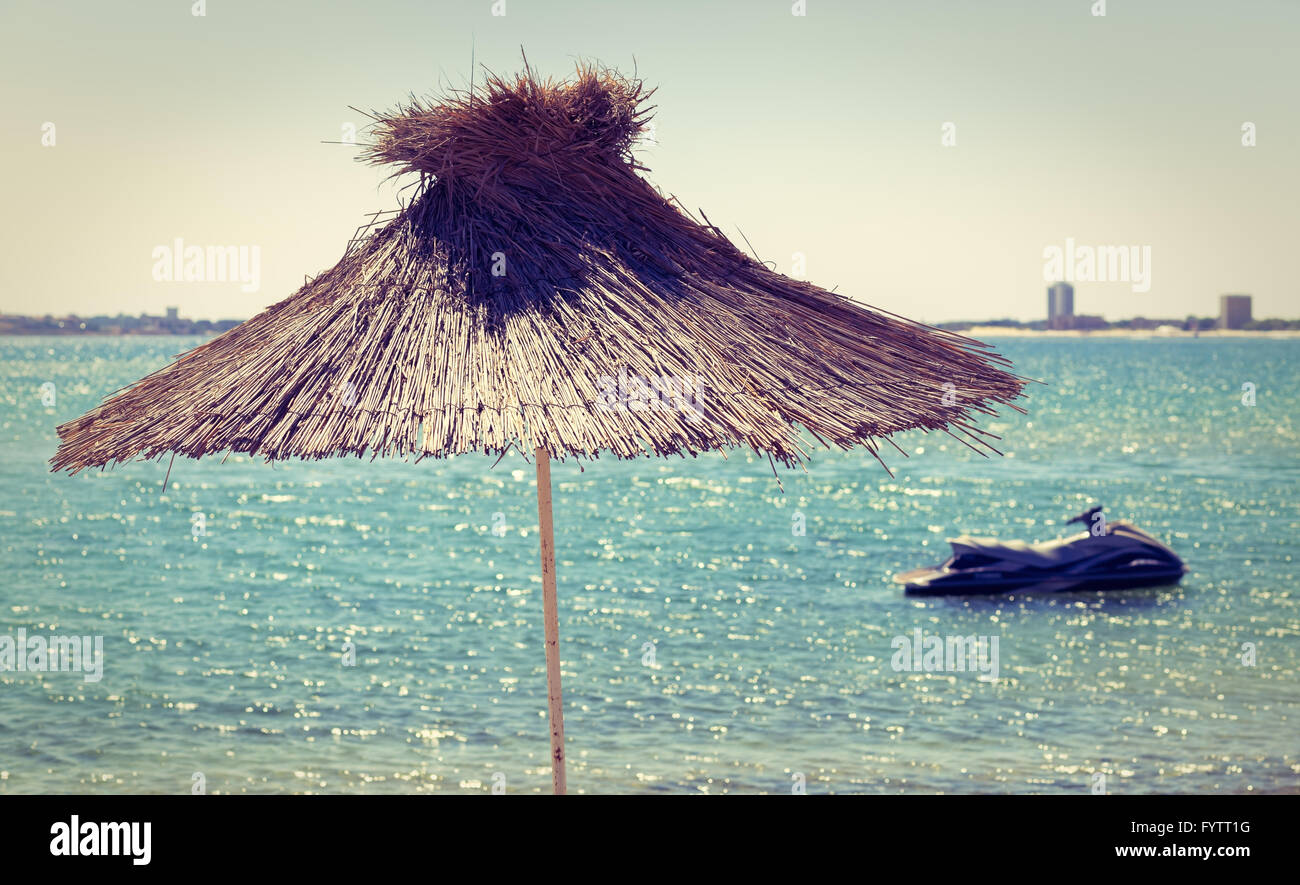 Straw beach umbrella Stock Photo - Alamy
